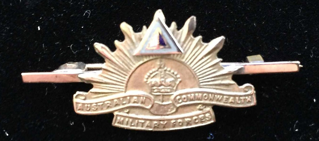 A WW2 rising sun broach complete with colour patch for the Service Cor ...